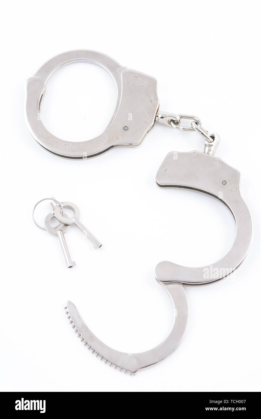 Shiny metal chrome handcuffs on a white background Stock Photo - Alamy