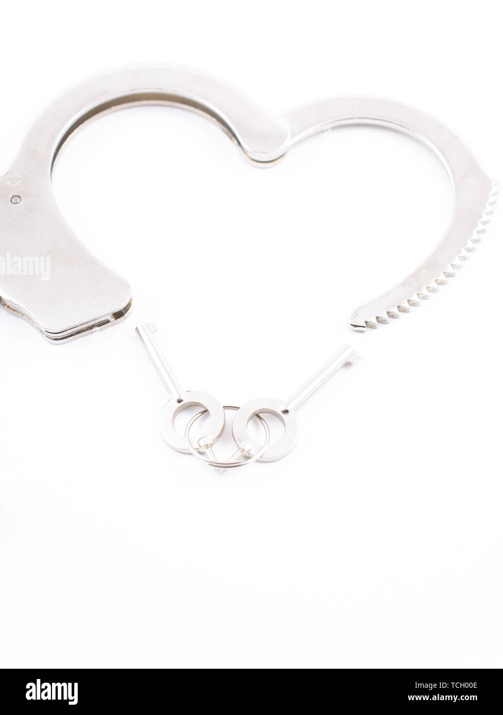 Shiny metal chrome handcuffs on a white background Stock Photo - Alamy