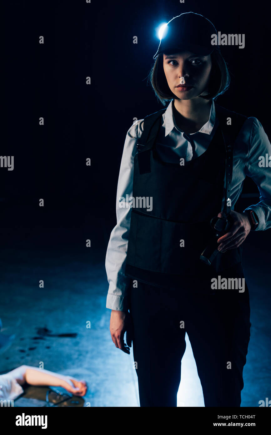investigator in uniform standing near corpse at crime scene Stock Photo ...