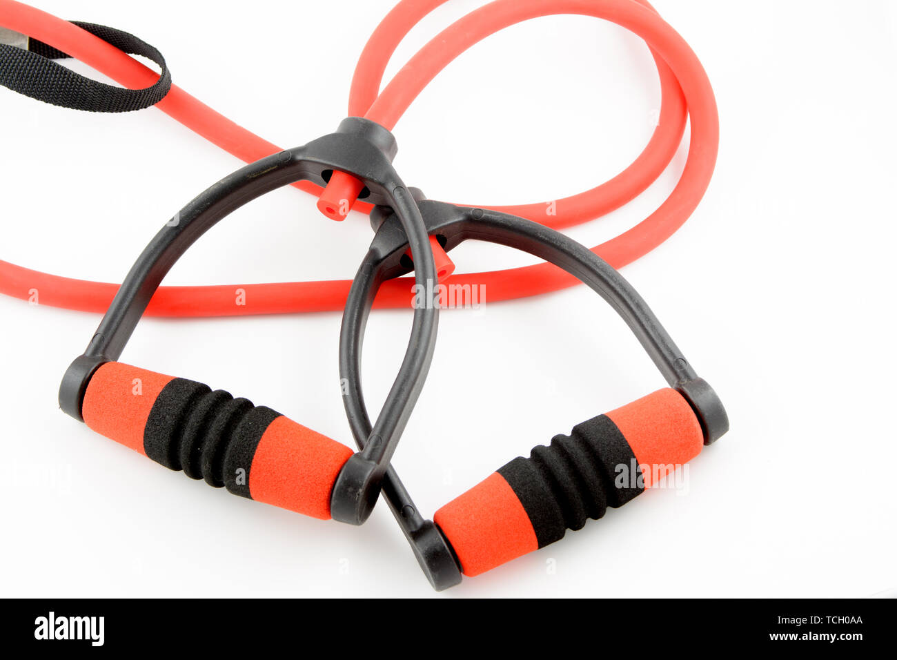 Red resistance bands with red black plastic handles Stock Photo - Alamy