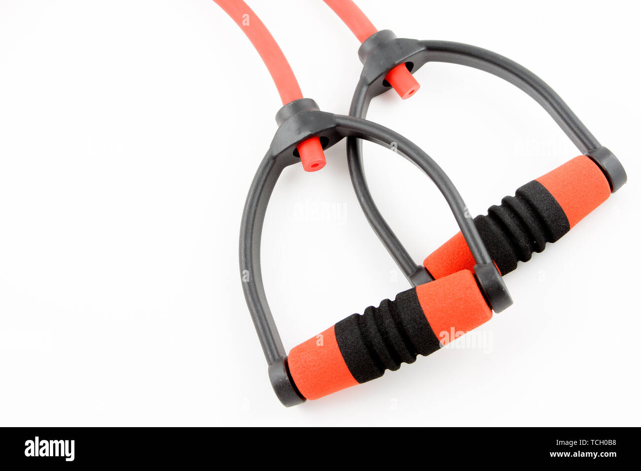 Red resistance bands with red black plastic handles Stock Photo - Alamy