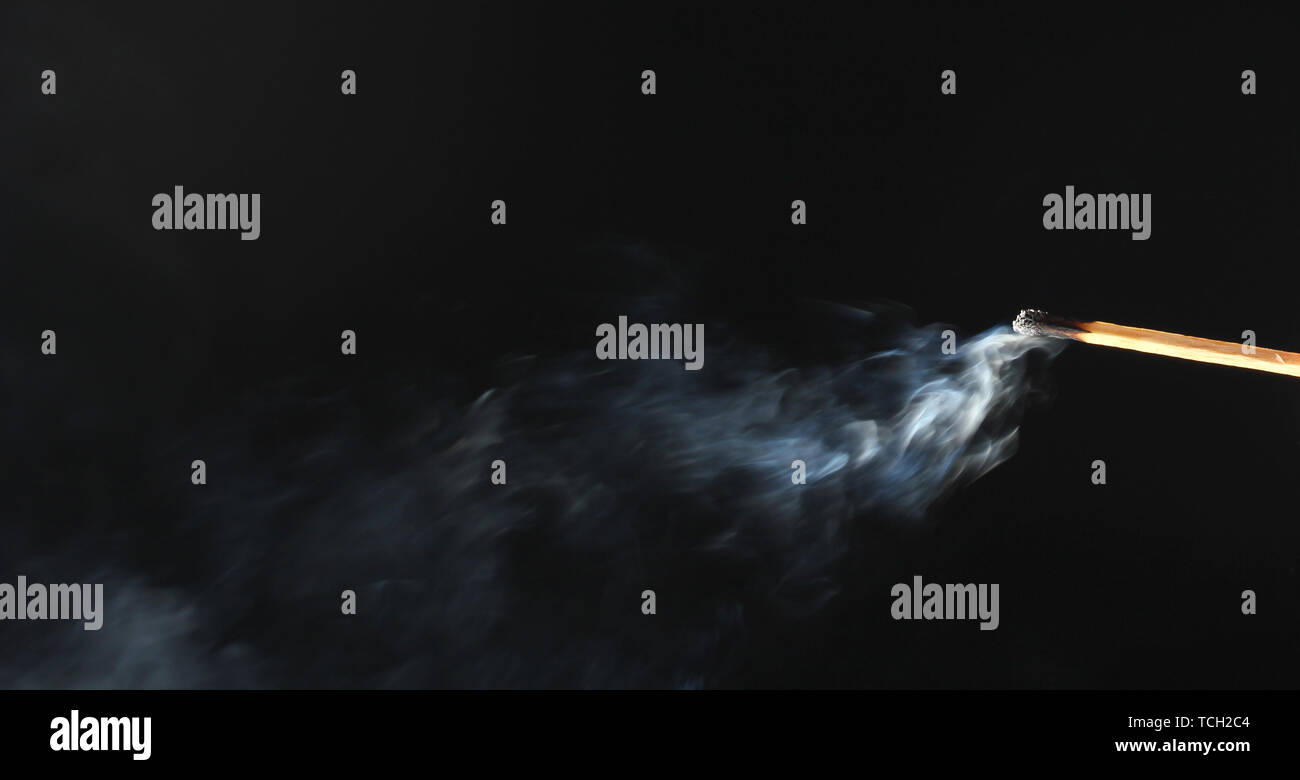 match with abstract smoke on black background Stock Photo - Alamy
