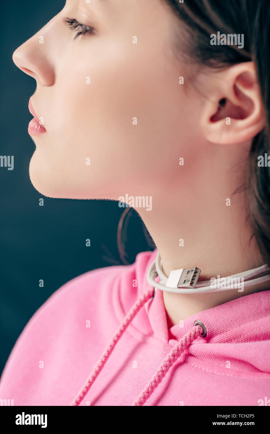 pretty young girl with usb cable around neck isolated on green ...