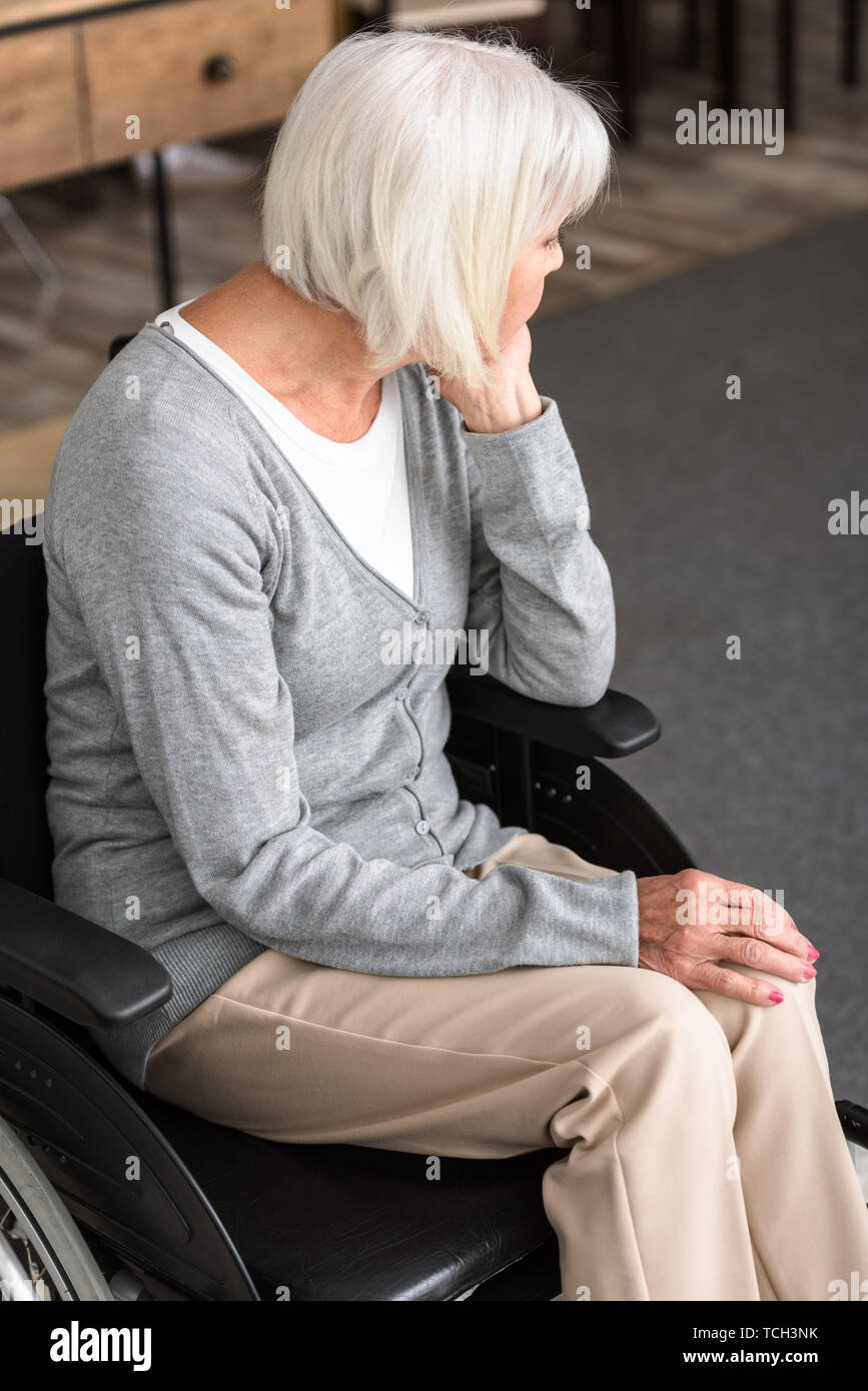 sad disabled senior woman sitting on wheelchair and looking away Stock ...