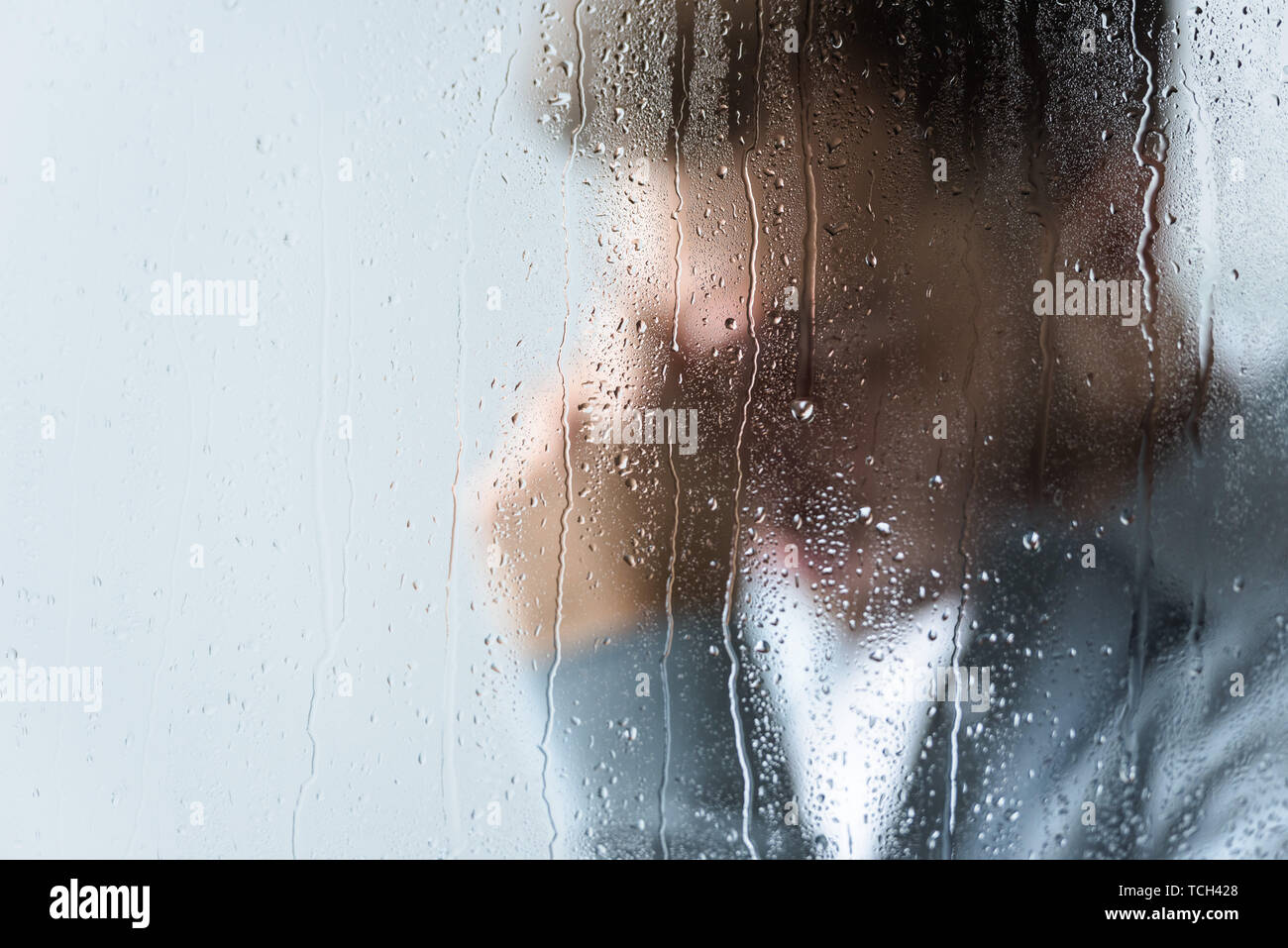 selective focus of crying man behind wet window Stock Photo - Alamy