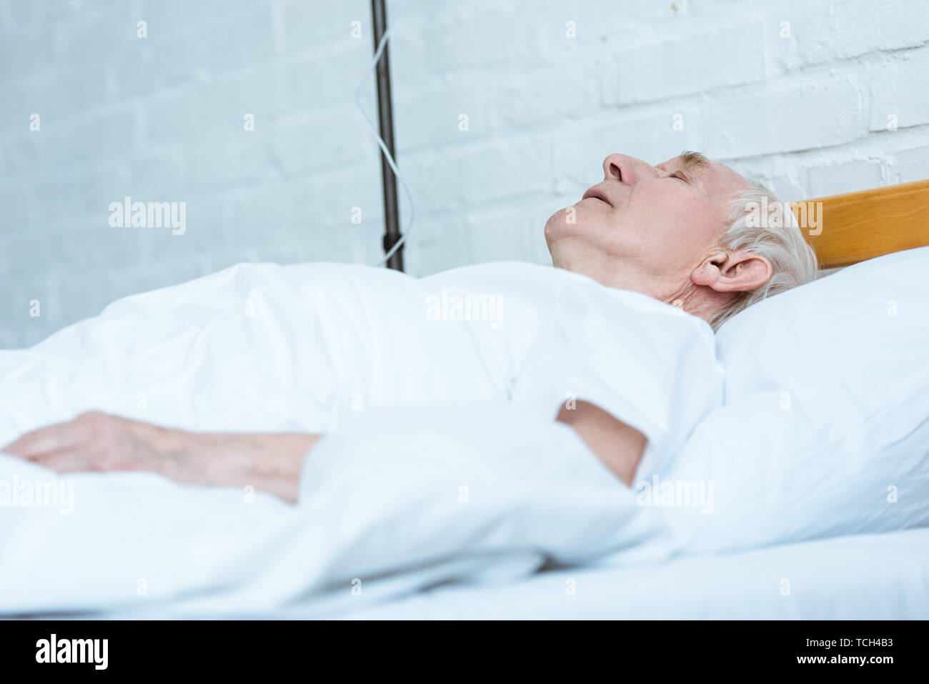 senior man in coma lying on bed in clinic Stock Photo - Alamy