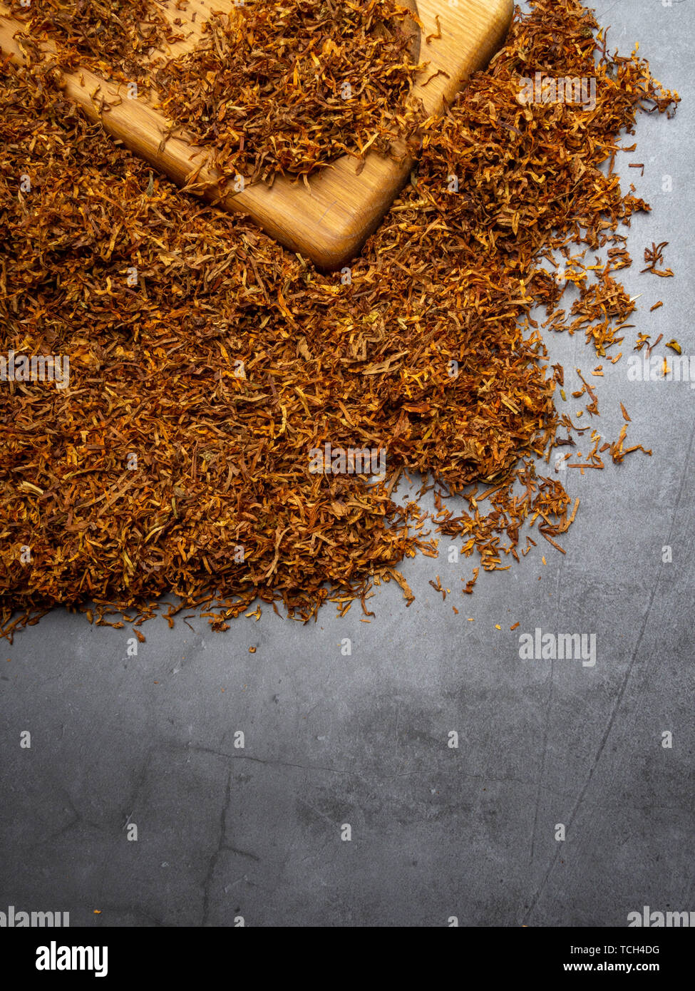 Dry tobacco leaves. High quality tobacco on wooden board close up ...