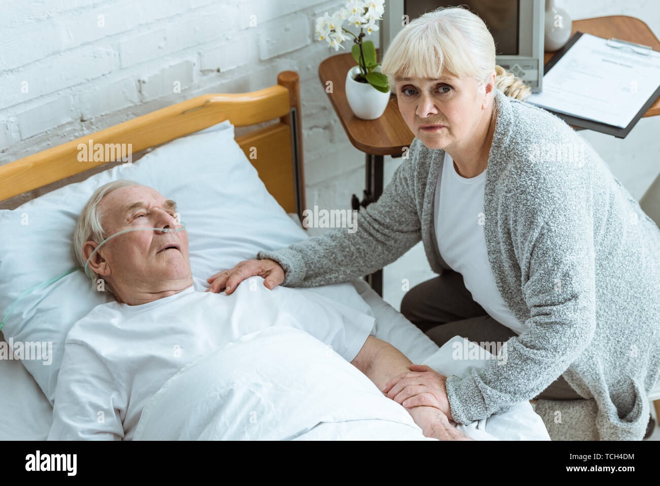 overhead view of sad senior woman and man in coma in hospital Stock ...