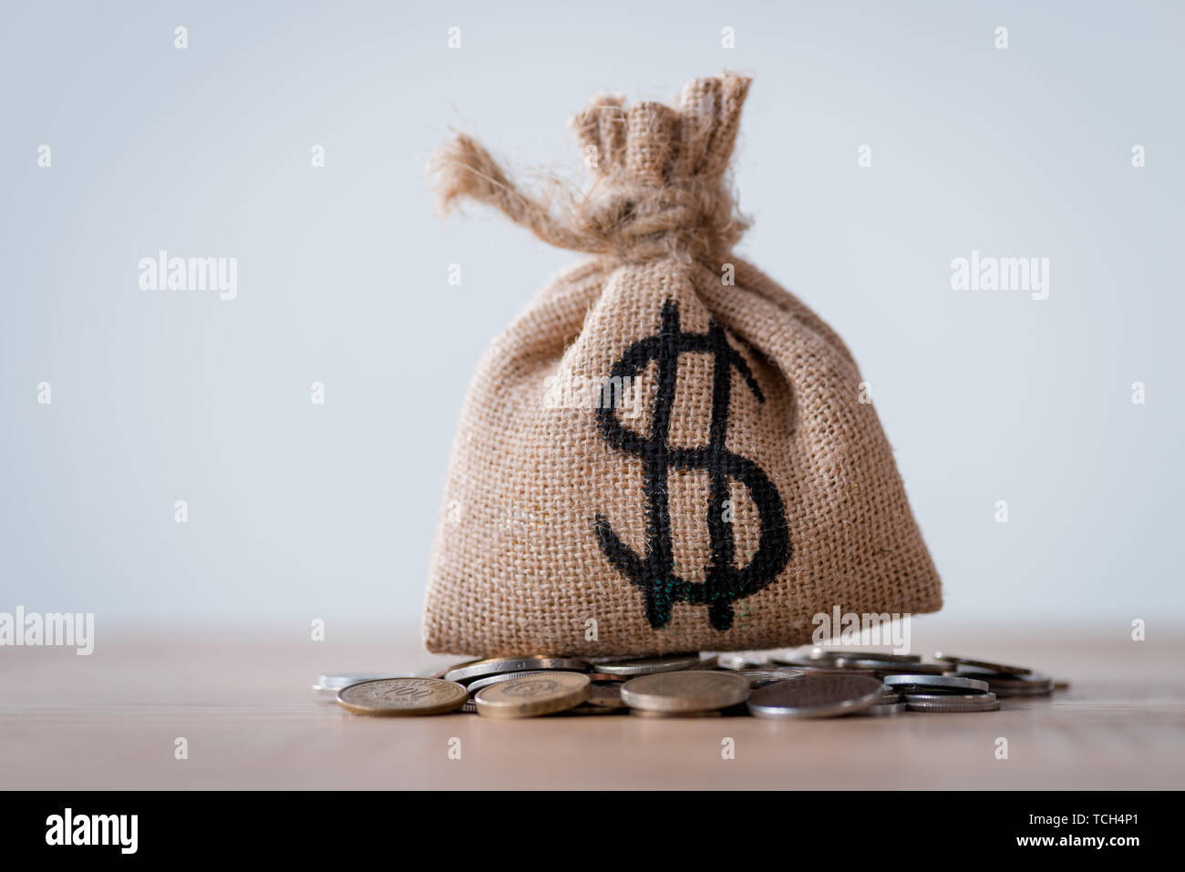 sackcloth money bag with dollar sign and metal coins isolated on grey ...