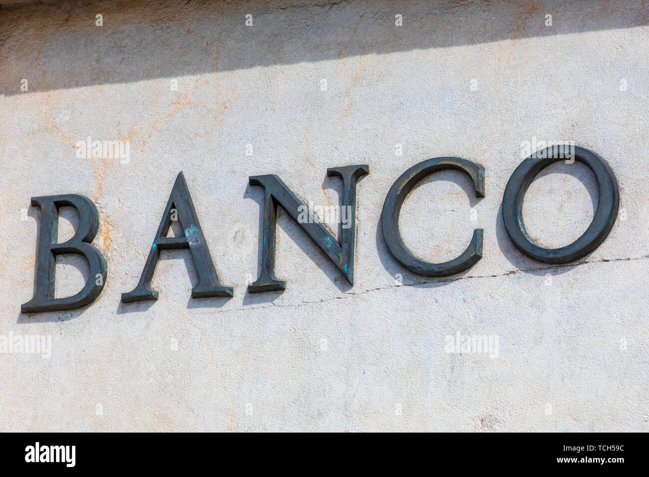 Bank word in Spanish. Metallic lettering Stock Photo - Alamy