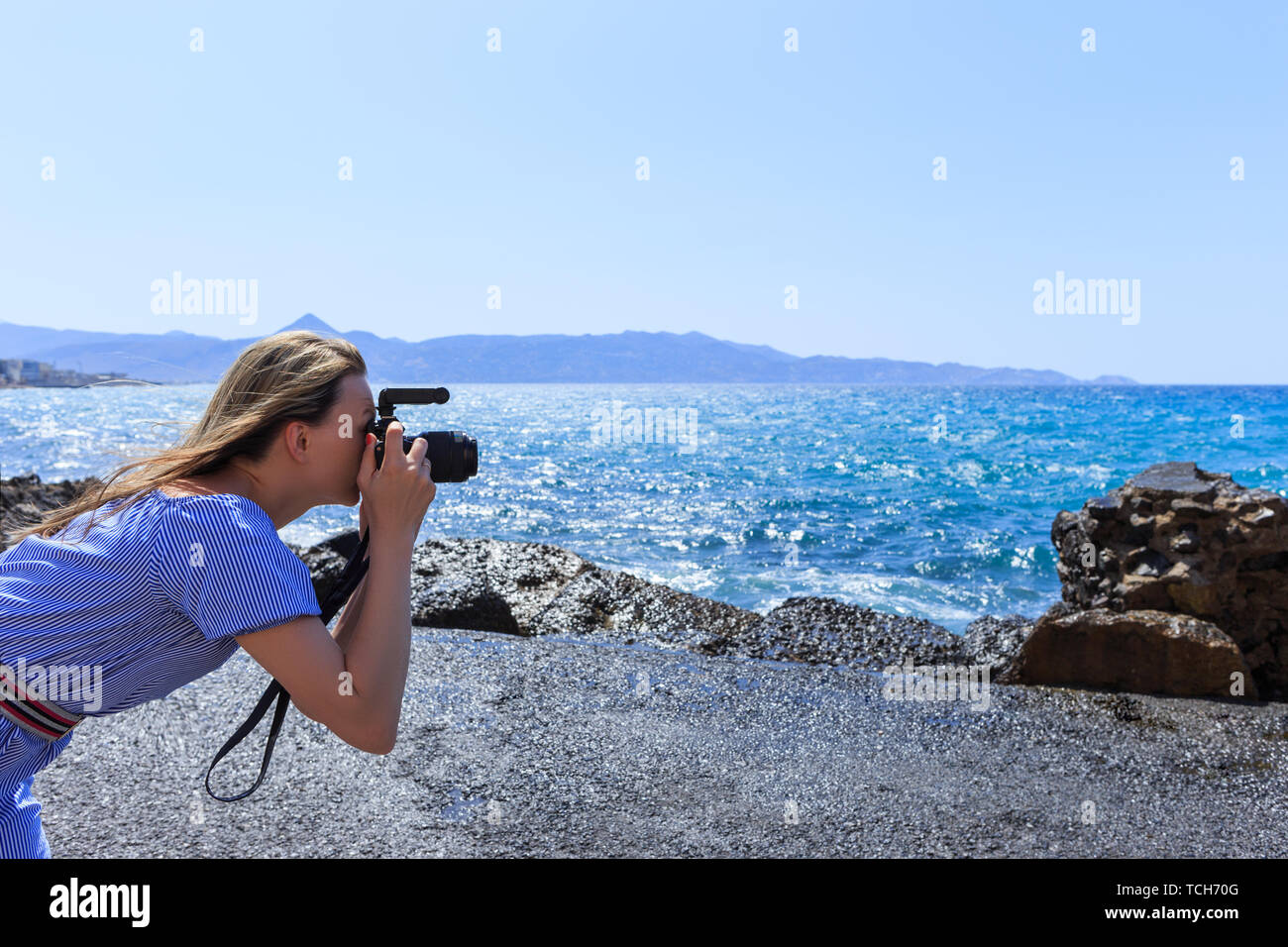 Woman photographer Nature photographer shooting the sea. Travel Concept ...