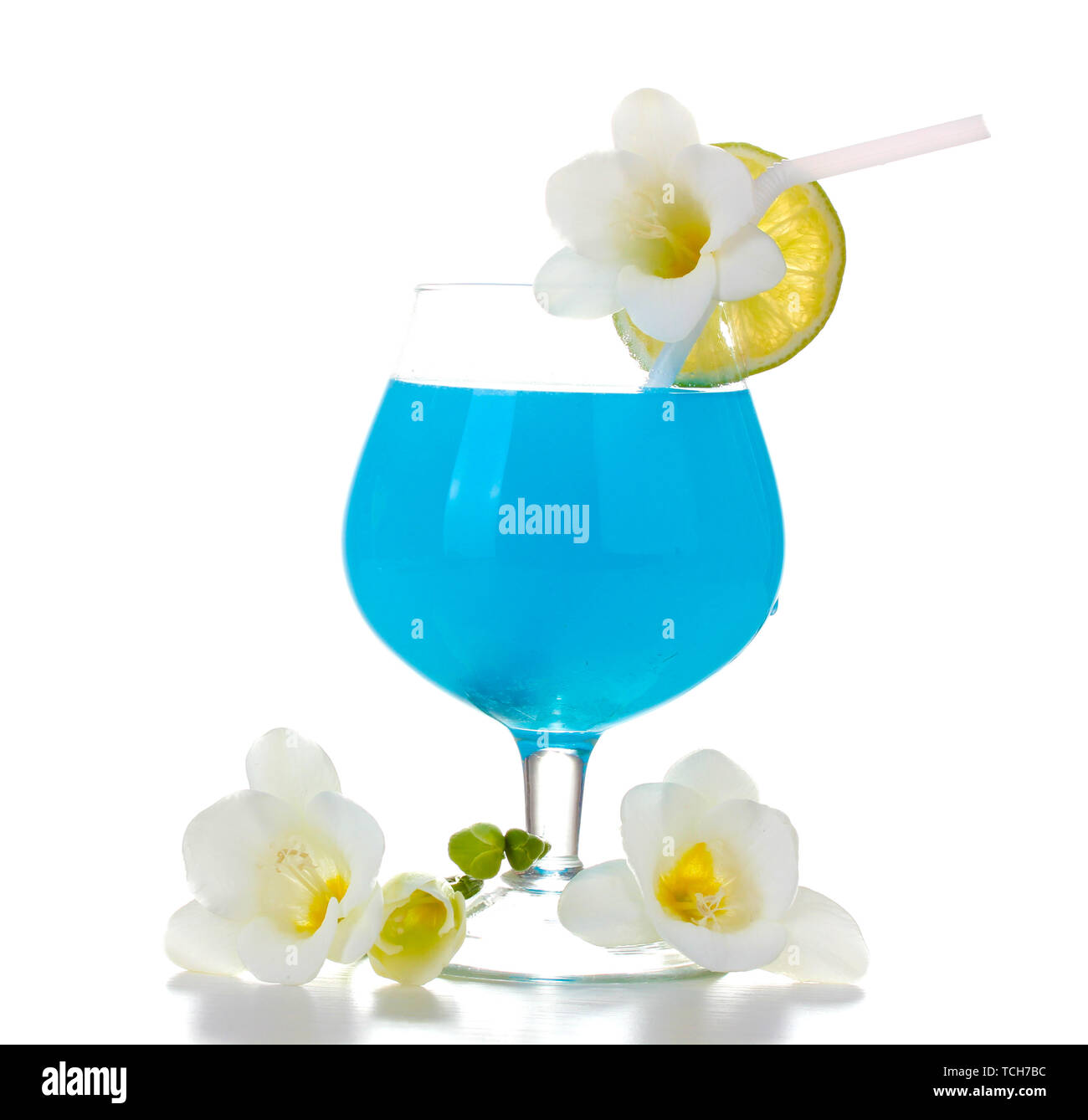 glass of blue cocktail with lime and flowers isolated on white Stock ...