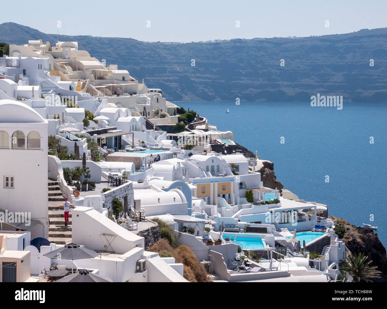 Crowded cave houses on cliff in Oia Stock Photo - Alamy
