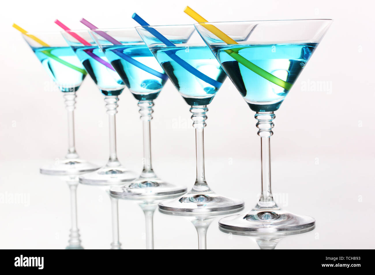 Blue cocktail in martini glasses isolated on white Stock Photo - Alamy