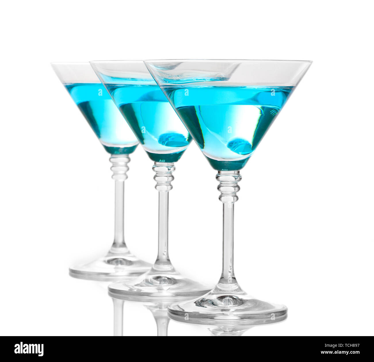 Blue cocktail in martini glasses isolated on white Stock Photo - Alamy