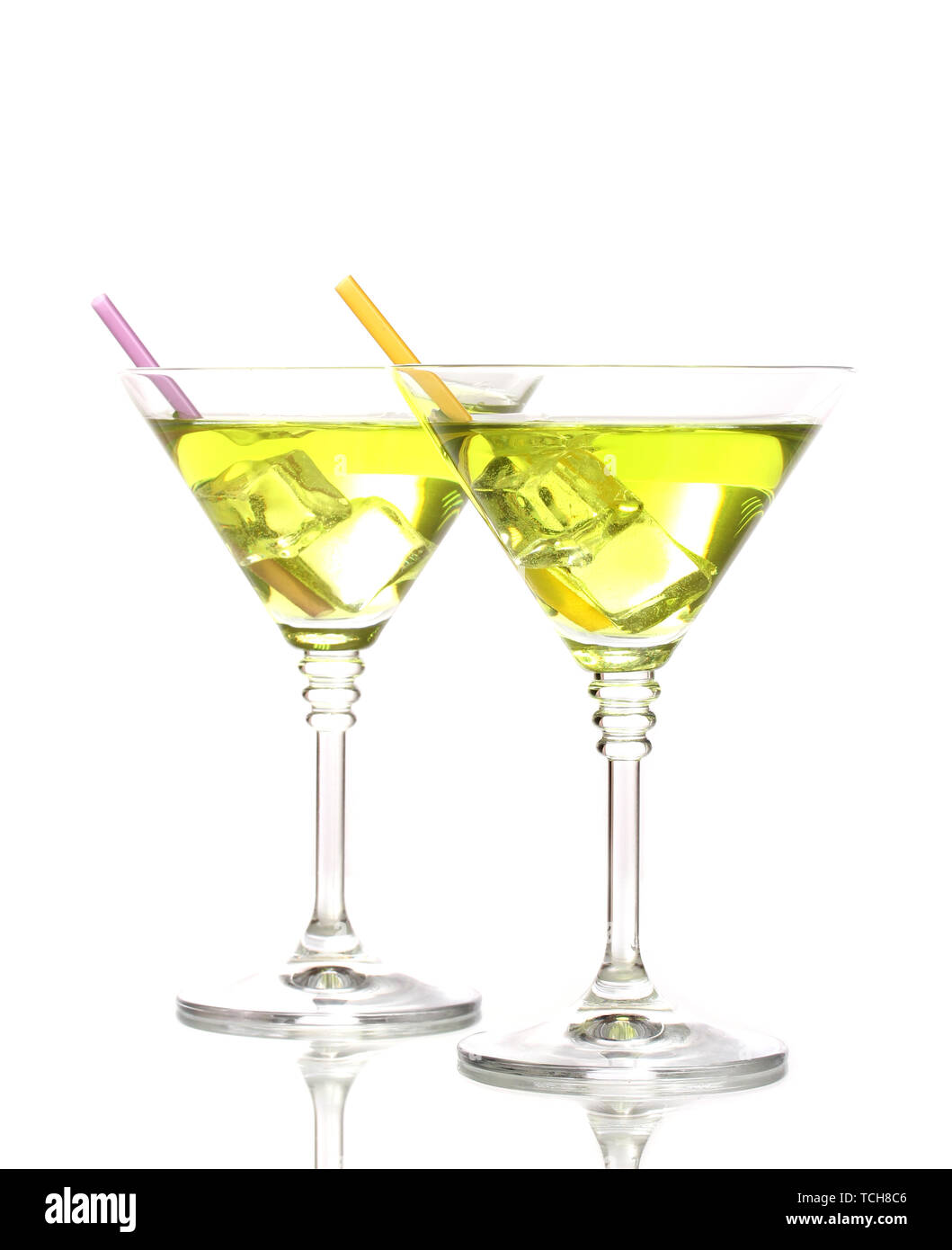 Yellow cocktail in martini glasses isolated on white Stock Photo - Alamy