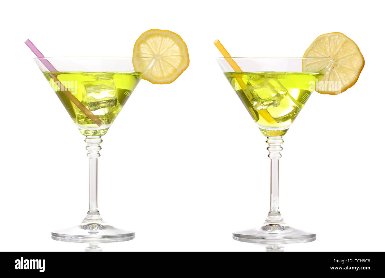 Yellow cocktail in martini glasses isolated on white Stock Photo - Alamy