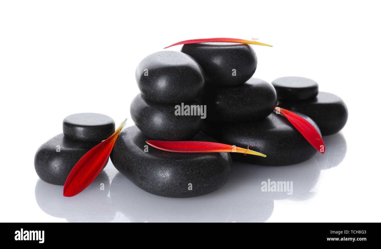 Spa stones and red petals isolated on white Stock Photo - Alamy