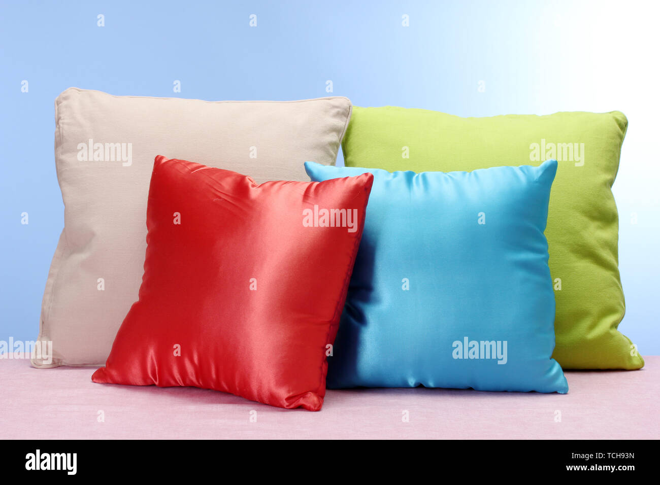 bright pillows on blue background Stock Photo - Alamy