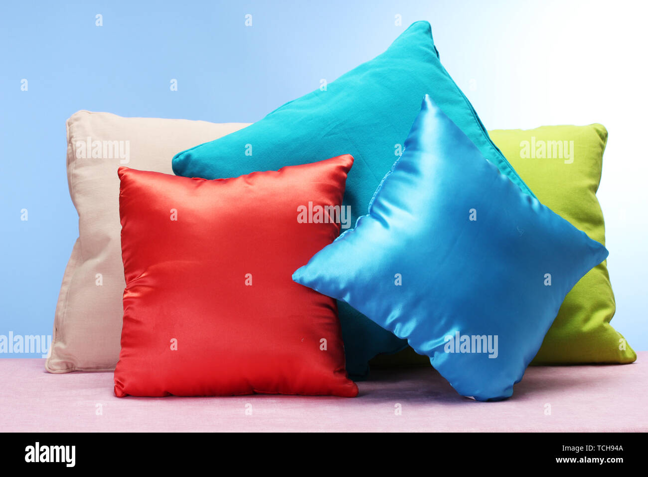 bright pillows on blue background Stock Photo - Alamy