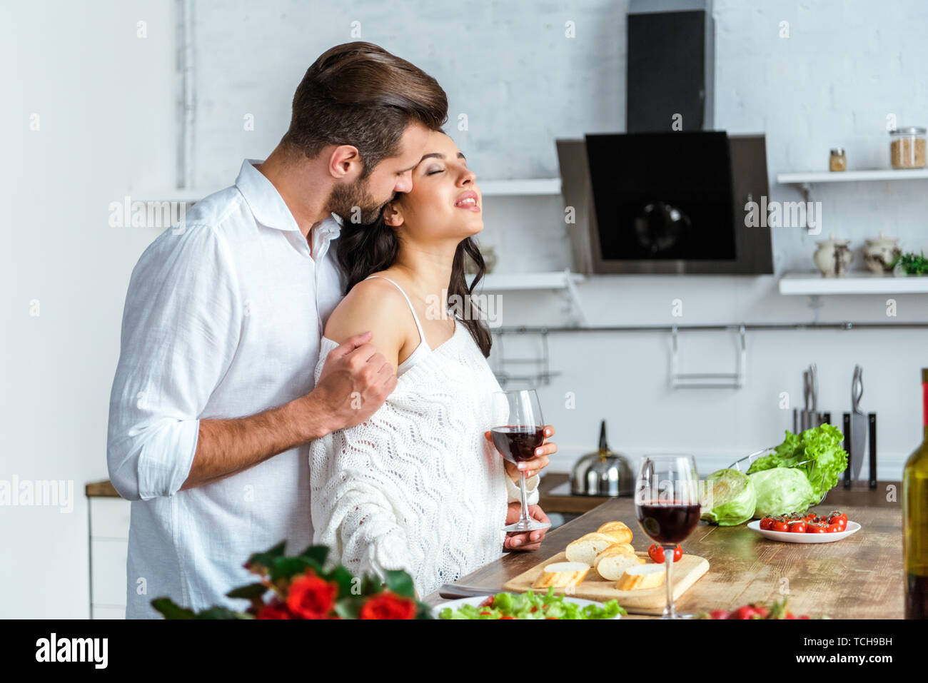 man passionate embracing joyful woman at kitchen Stock Photo - Alamy