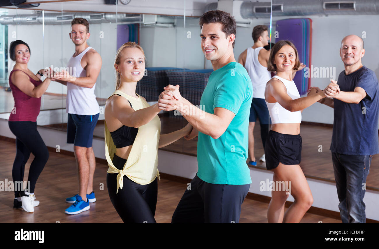 Young men and women dancing a salsa o bachata in dance hall Stock Photo ...