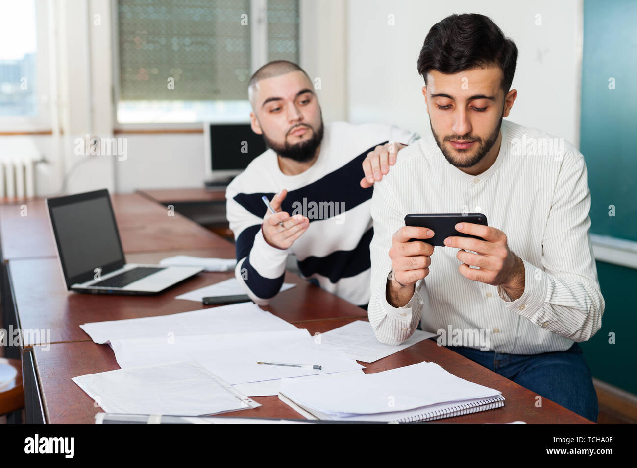 Friend distracting student hi-res stock photography and images - Alamy