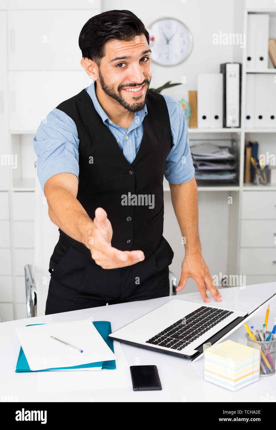 Spanish man manager is going to meet first visitors in his office Stock ...