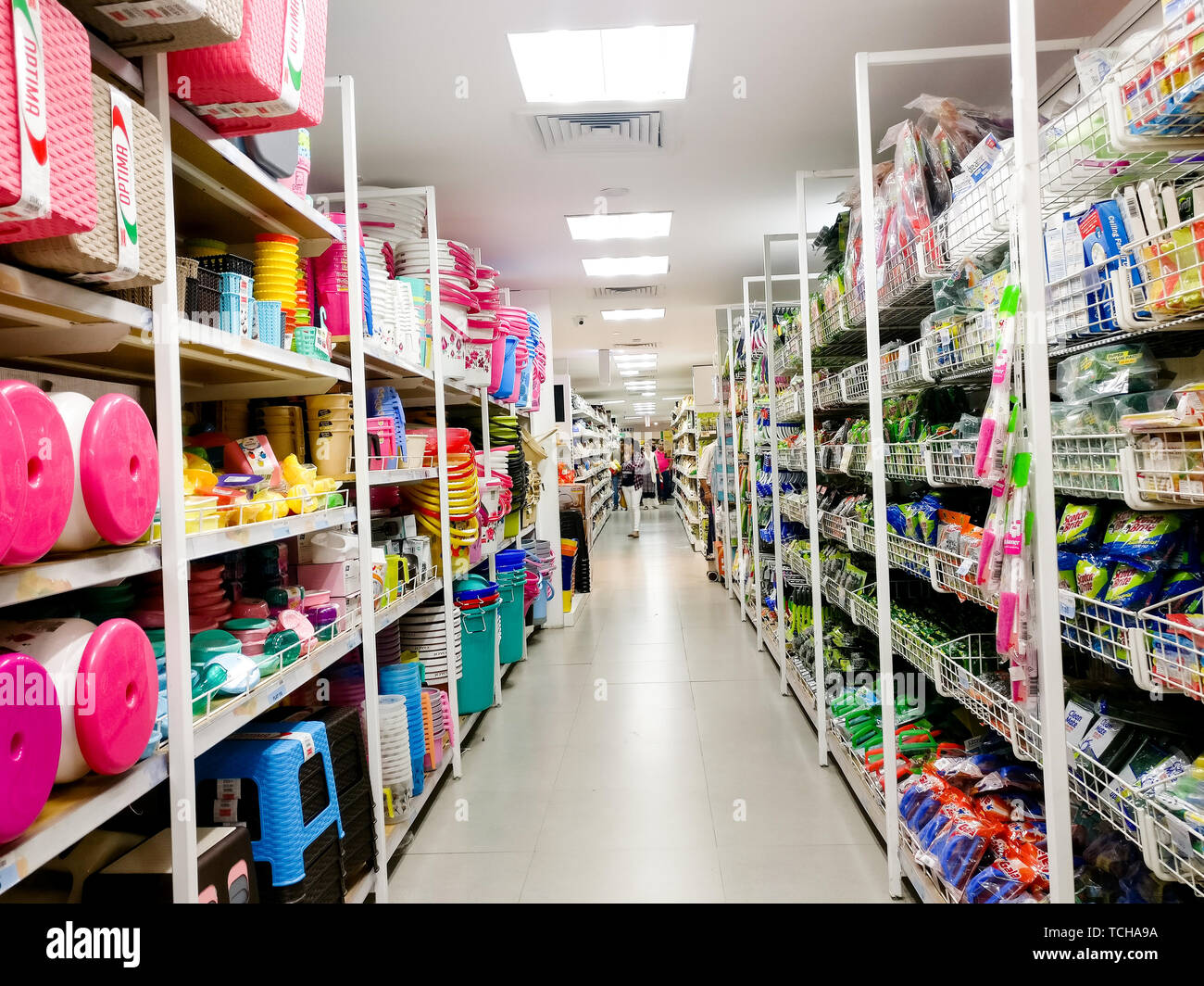 white supermarket shelves with plastic stools and home cleaning ...
