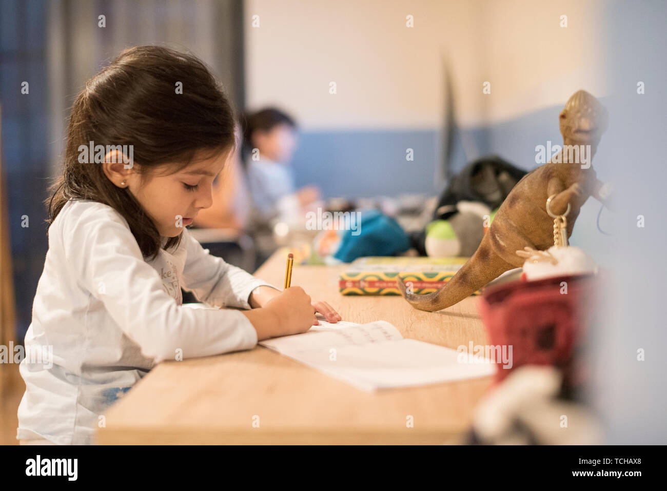 Little girl 6 years old doing homework at home in her room Stock Photo ...