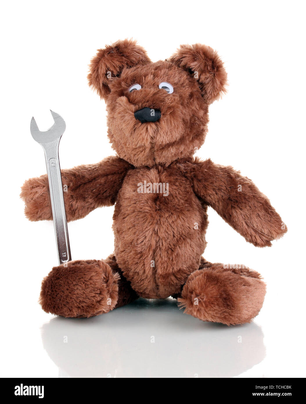 Sitting bear toy with wrench isolated on white Stock Photo - Alamy