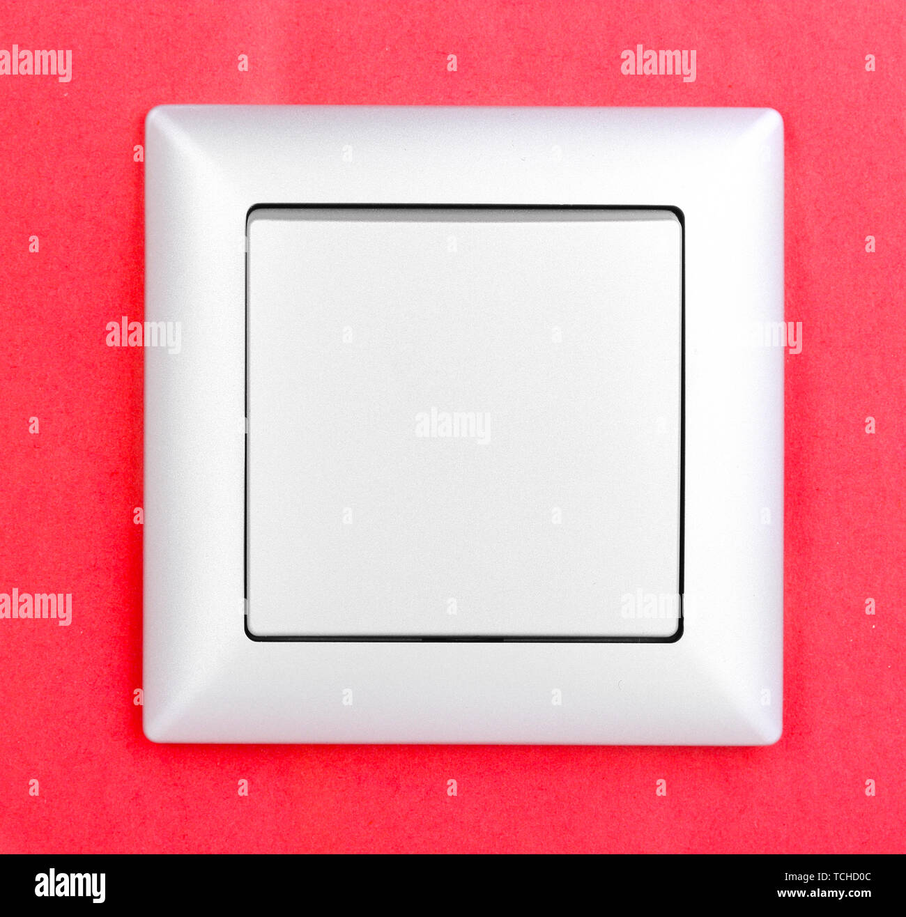 Modern light switch on red background Stock Photo - Alamy