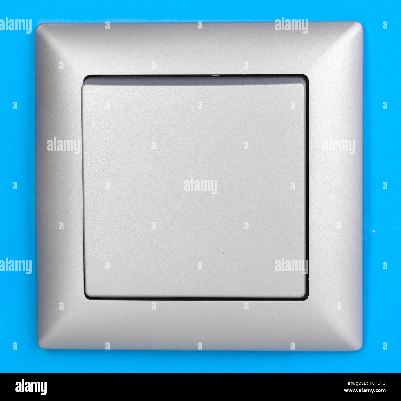 Modern light switch on blue background Stock Photo - Alamy
