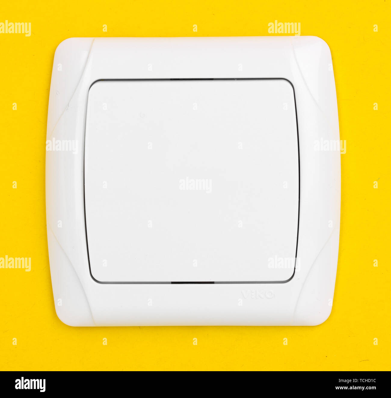 Modern light switch on yellow background Stock Photo - Alamy
