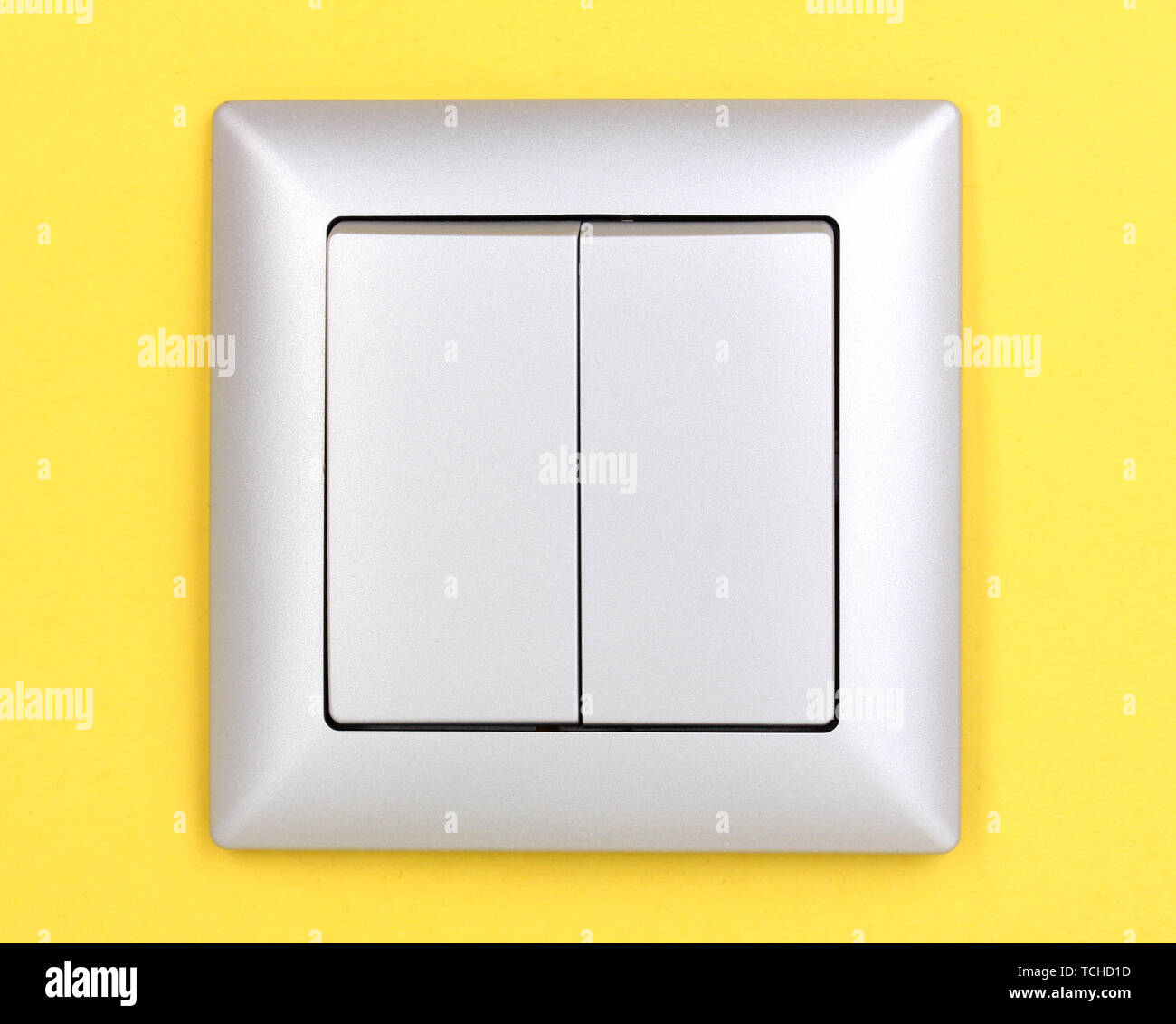 Modern light switch on yellow background Stock Photo - Alamy