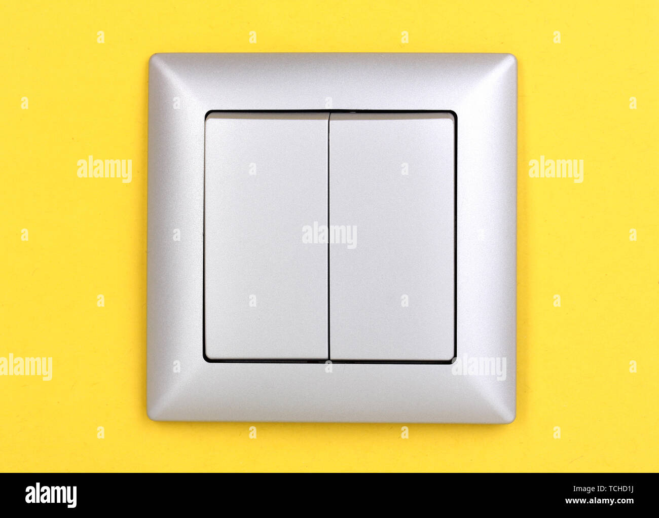 Modern light switch on yellow background Stock Photo - Alamy