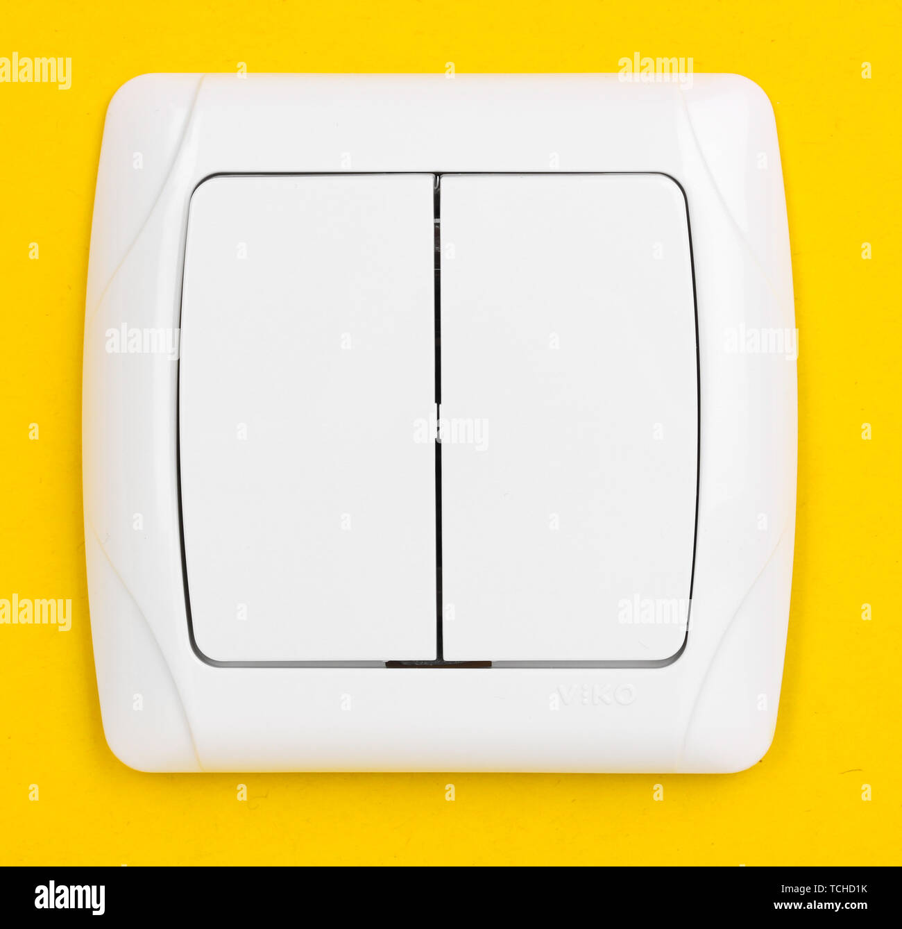 Modern light switch on yellow background Stock Photo - Alamy