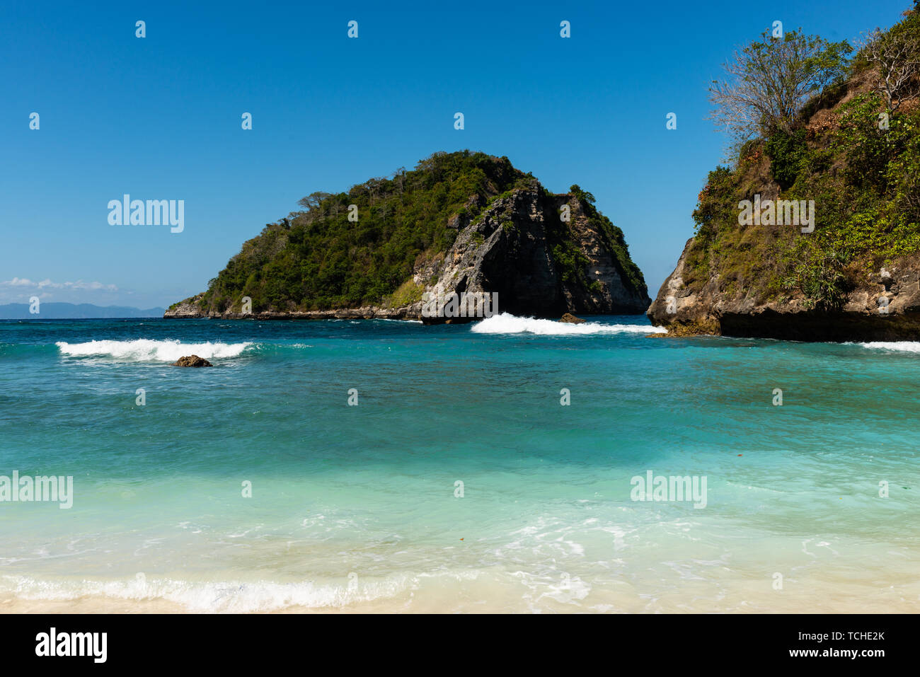 View of tropical beach, sea rocks and turquoise ocean, blue sky. Atuh ...