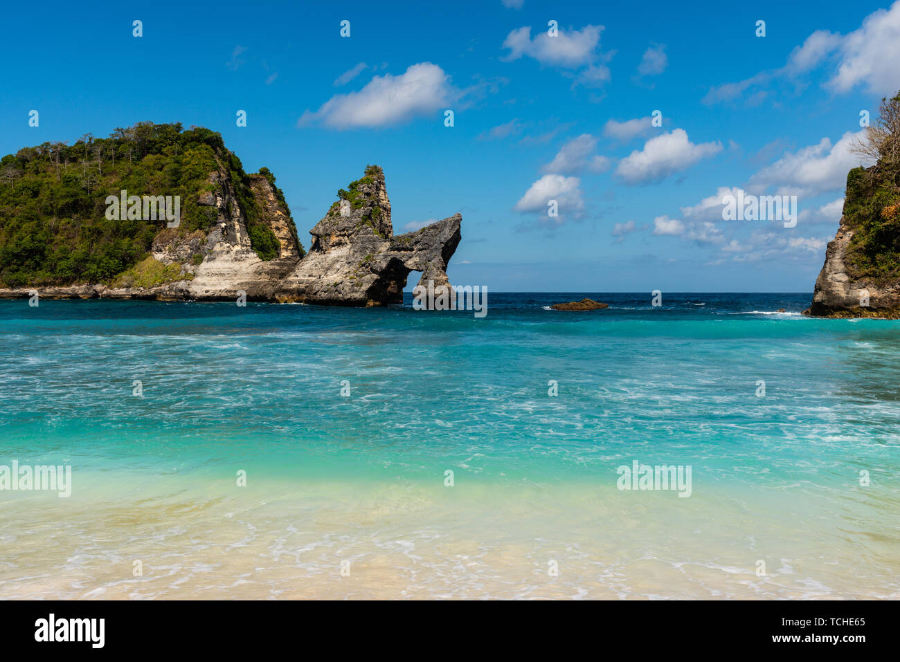 View of tropical beach, sea rocks and turquoise ocean, blue sky. Atuh ...