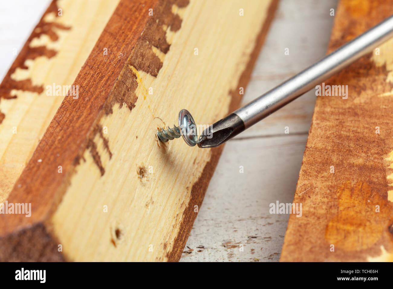 screw screwed into a wooden bar Stock Photo - Alamy