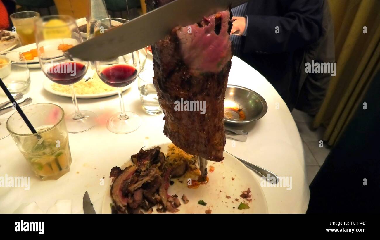 Serving to a customer a cut of Calf with vegetables roast beef, cut ...