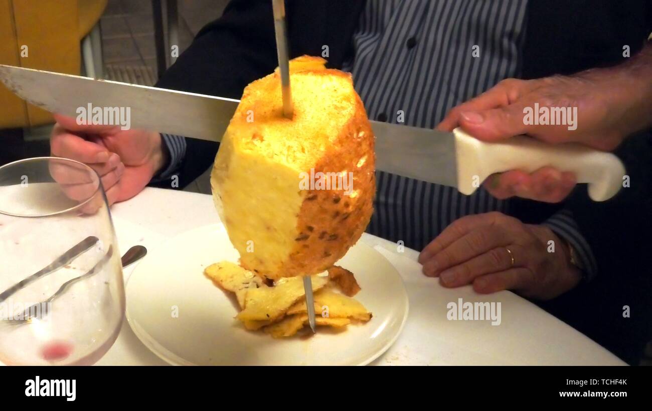 Close up of hot pineapple slices with sugar and cinnamon on the sword ...