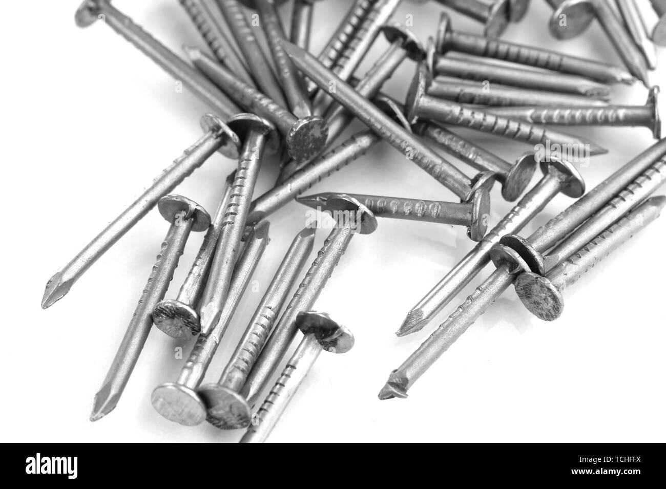 Metal nails isolated on white Stock Photo - Alamy