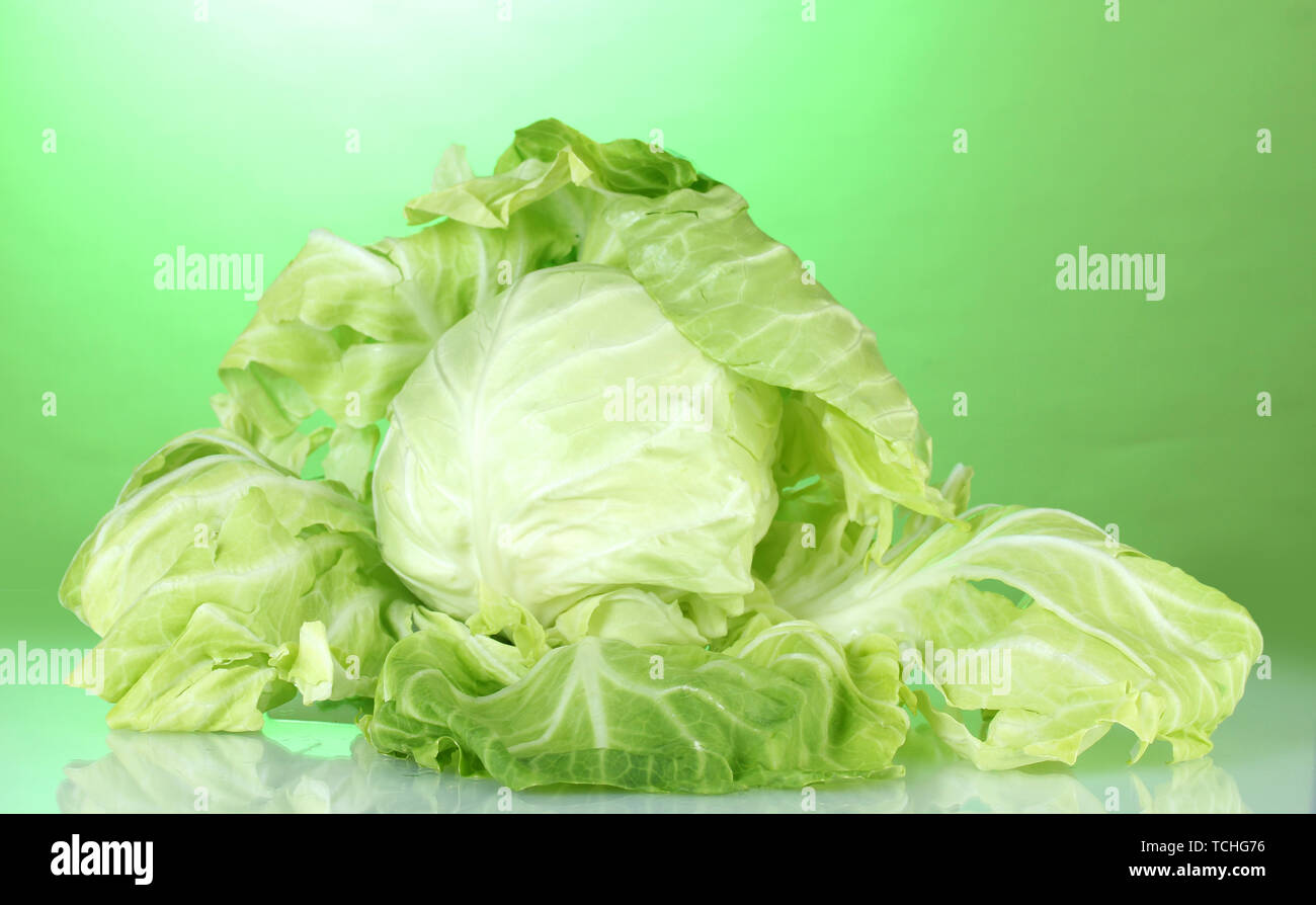 Cabbage on bright green background Stock Photo - Alamy