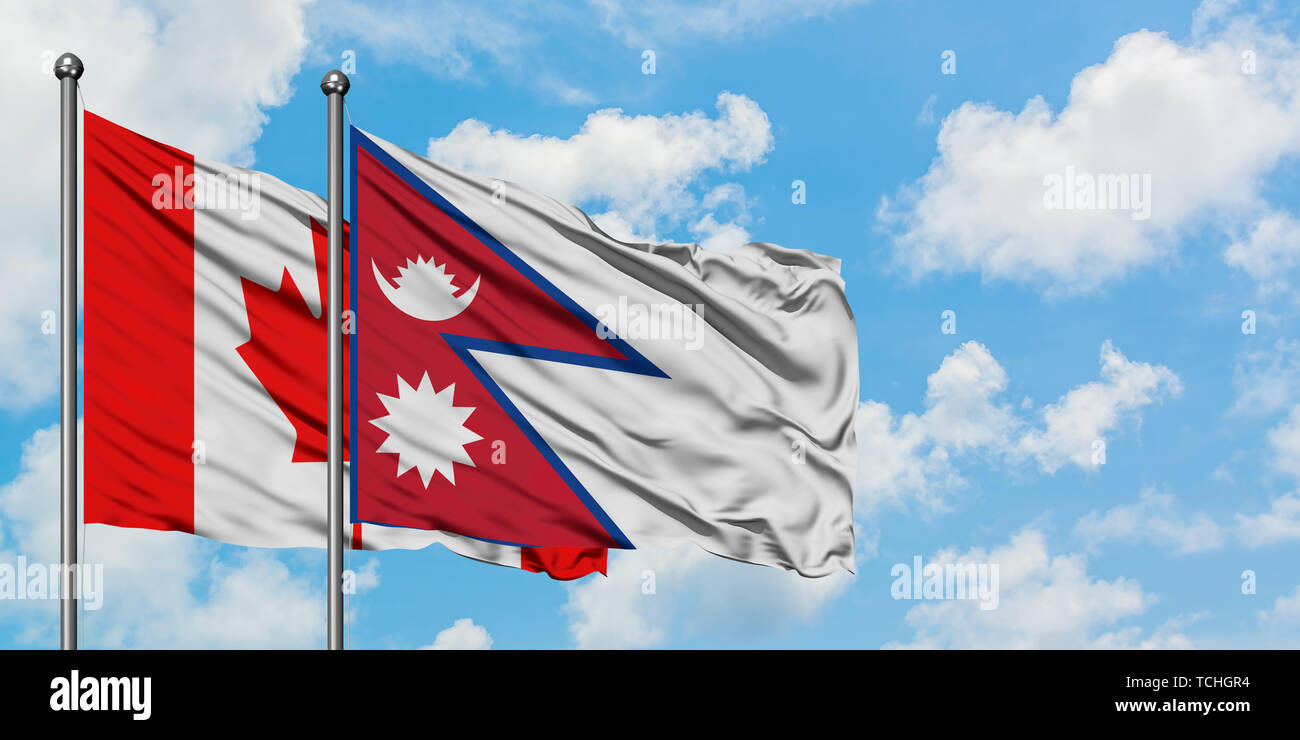 Canada and Nepal flag waving in the wind against white cloudy blue sky ...
