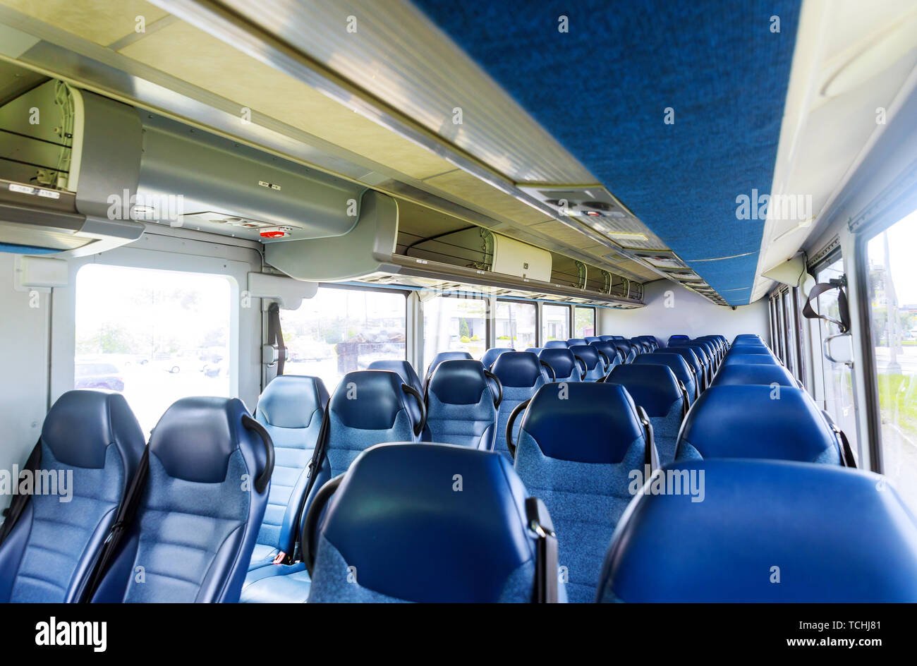 Open double interior of new modern empty chairs bus Stock Photo - Alamy