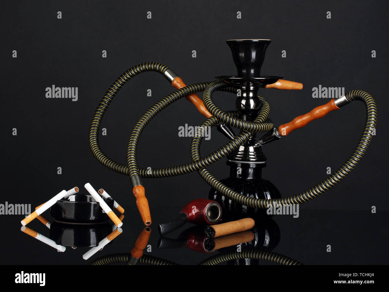 Smoking tools - a hookah, cigar, cigarette and pipe isolated on black ...