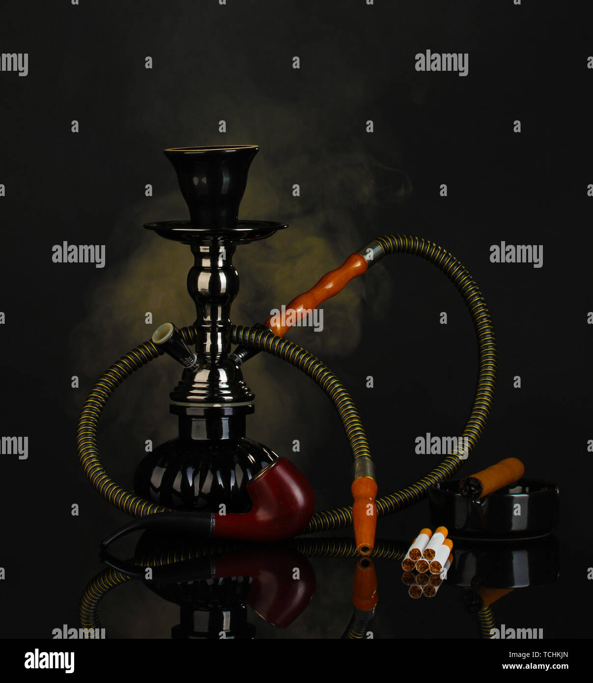 Smoking tools - a hookah, cigar, cigarette and pipe on black background ...