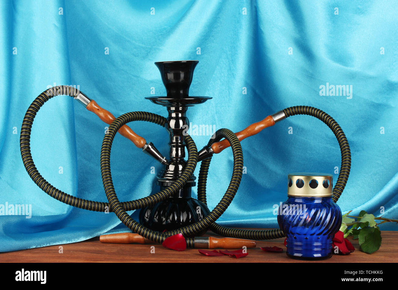 hookah on a wooden table on a background of blue curtain close-up Stock ...