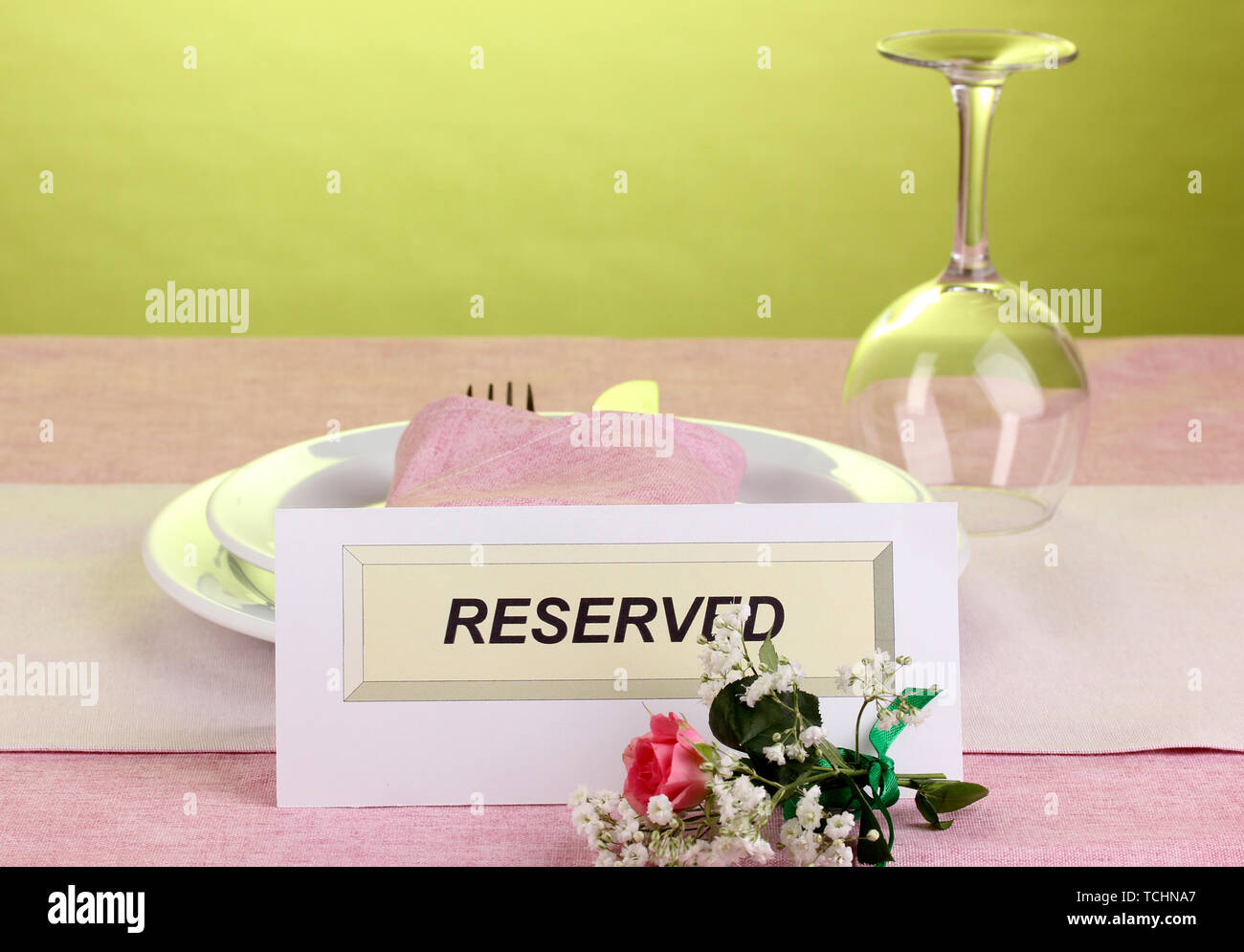 Table setting with reserved card in restaurant Stock Photo - Alamy